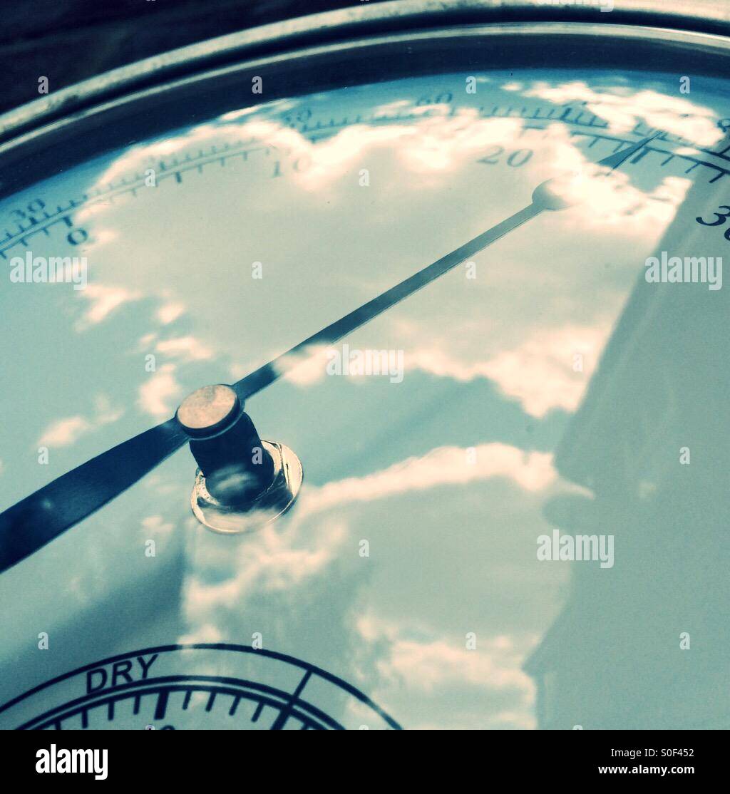 Garden thermometer indicates warm weather with a reflection of the sky ...