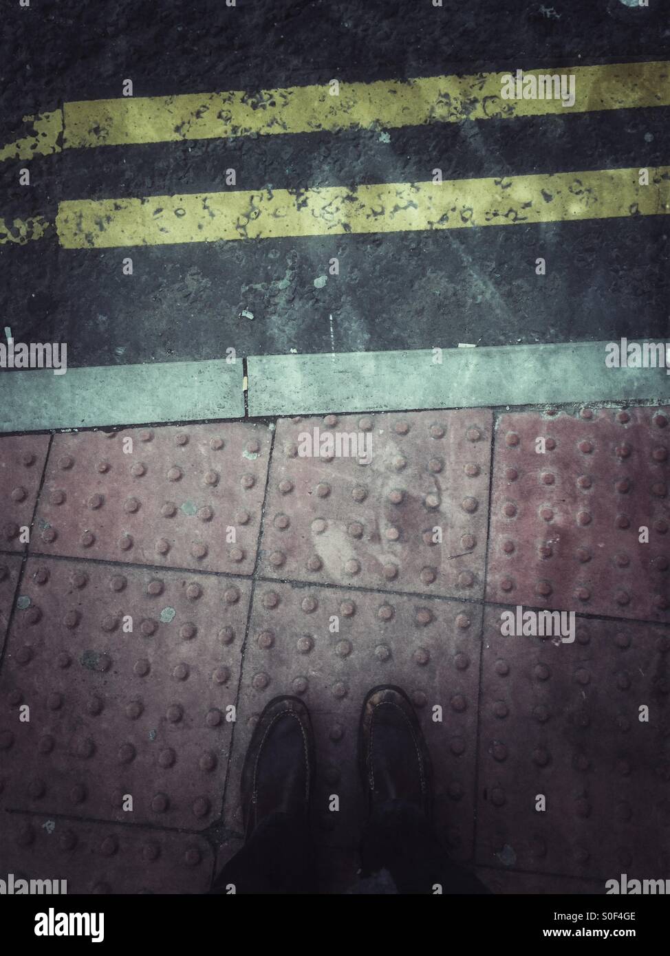 Man waiting patiently at a crossing Stock Photo - Alamy