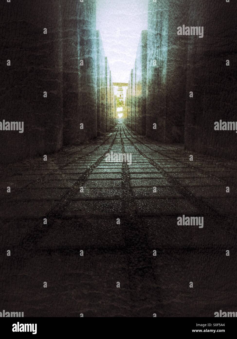 Narrow path with light at end Stock Photo - Alamy