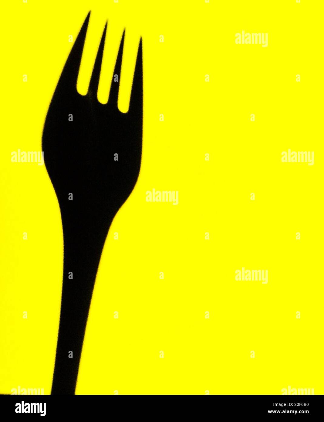 A fork on yellow background Stock Photo - Alamy