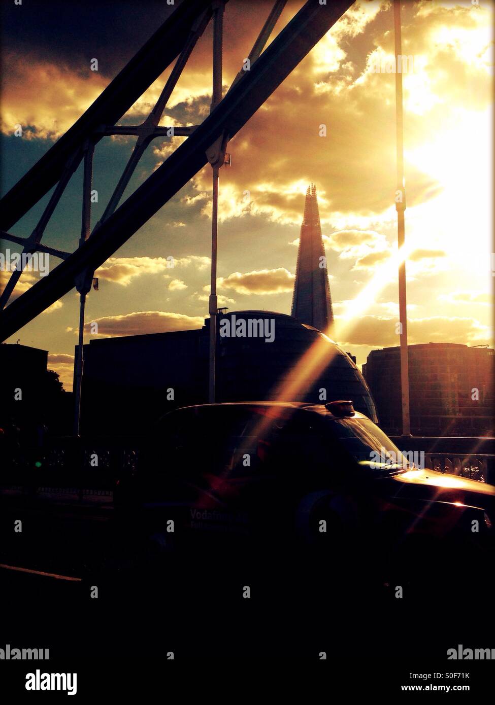 Sunset over Tower Bridge showing the Shard and City Hall in background ...