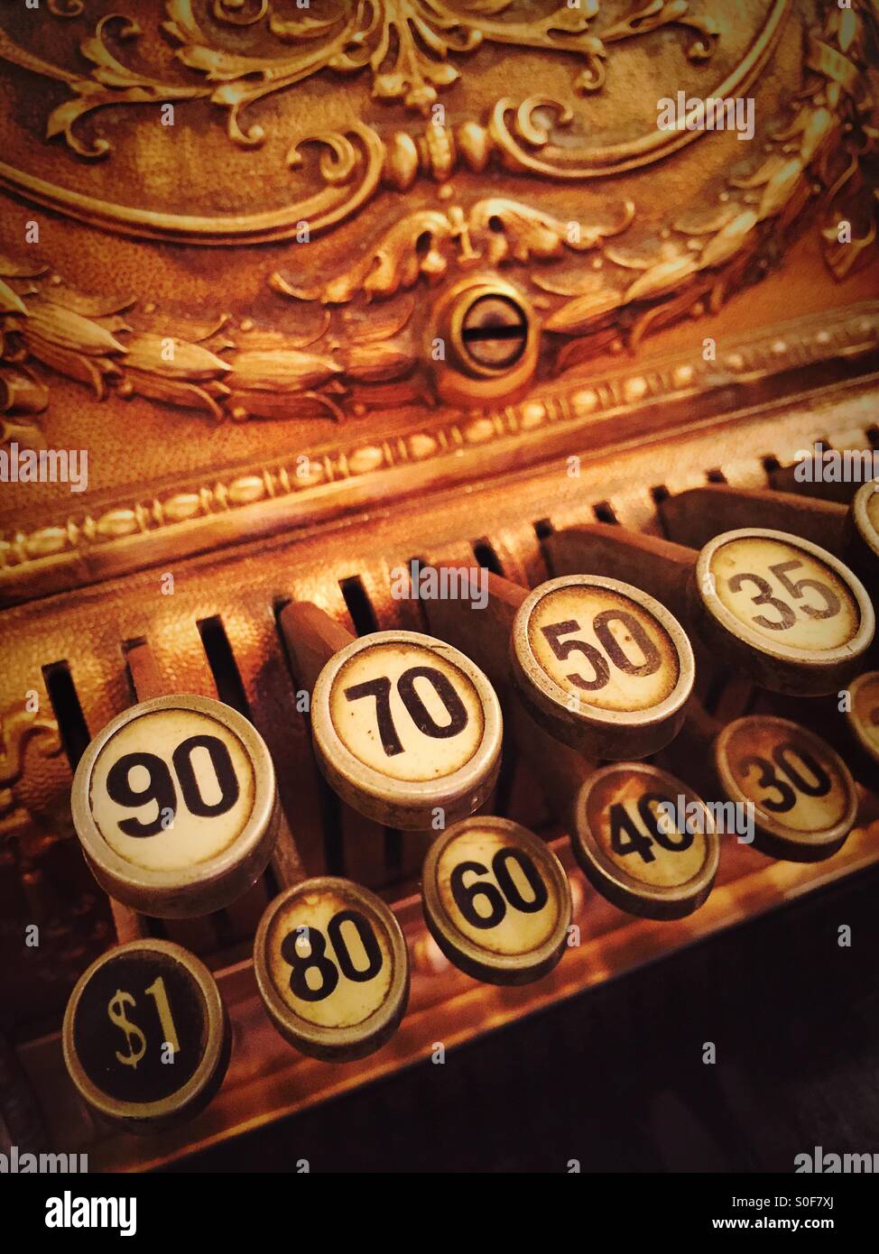 Vintage brass cash register keys Stock Photo - Alamy