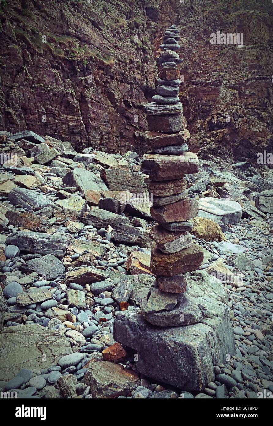A tall stack of stones on a beach Stock Photo - Alamy