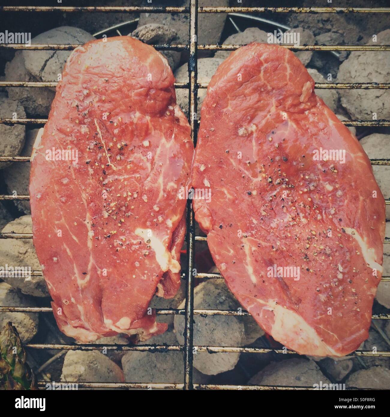 Two fillet steaks on a BBQ close up Stock Photo - Alamy