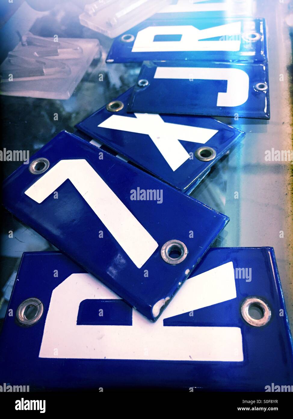 Number and letter tag display in antique store Stock Photo - Alamy