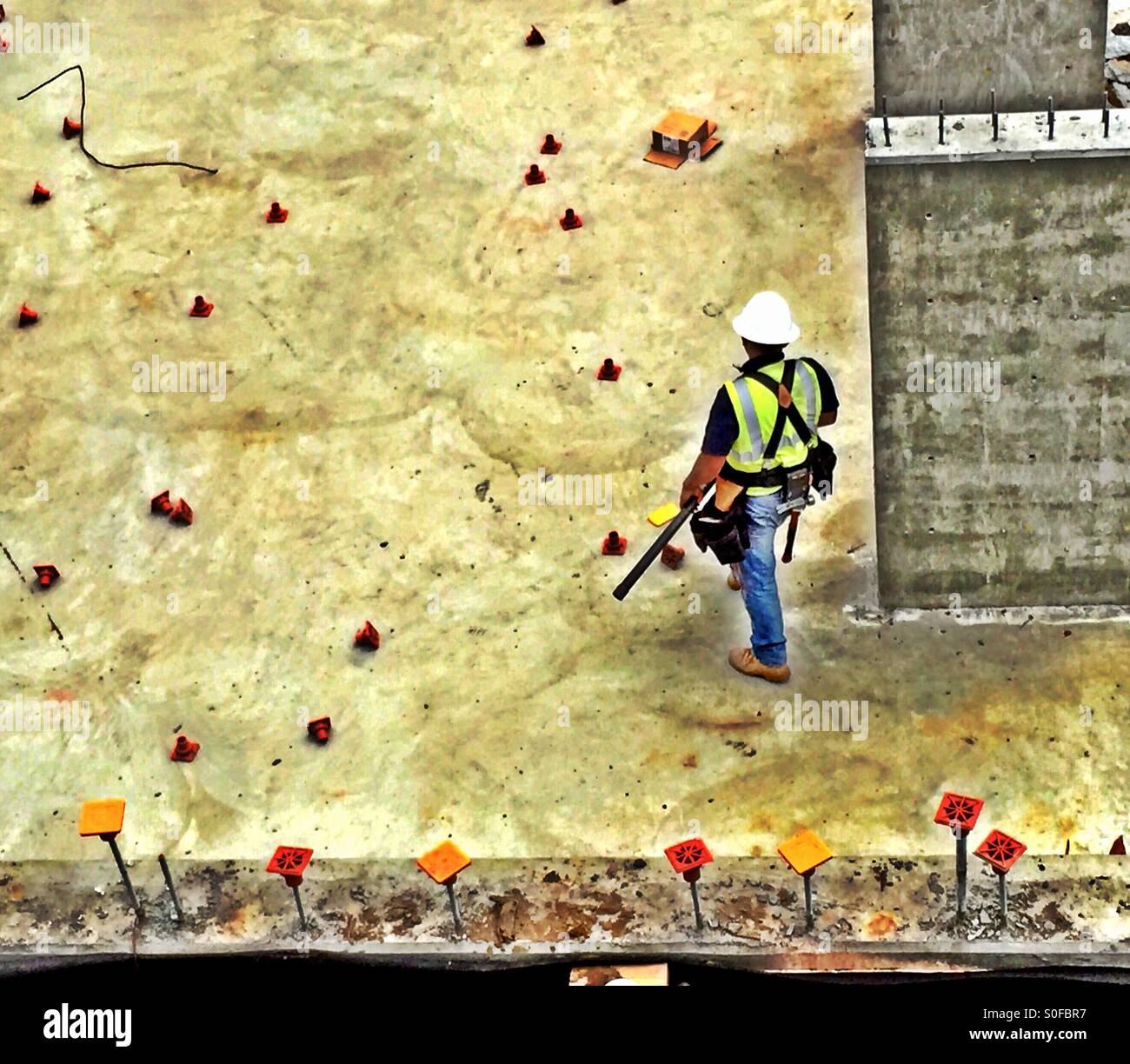 Construction worker installing electrical conduit in the foundation of ...