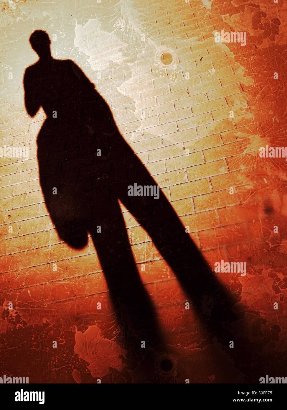 Shadow of a man with a Large and Heavy Bag Stock Photo - Alamy