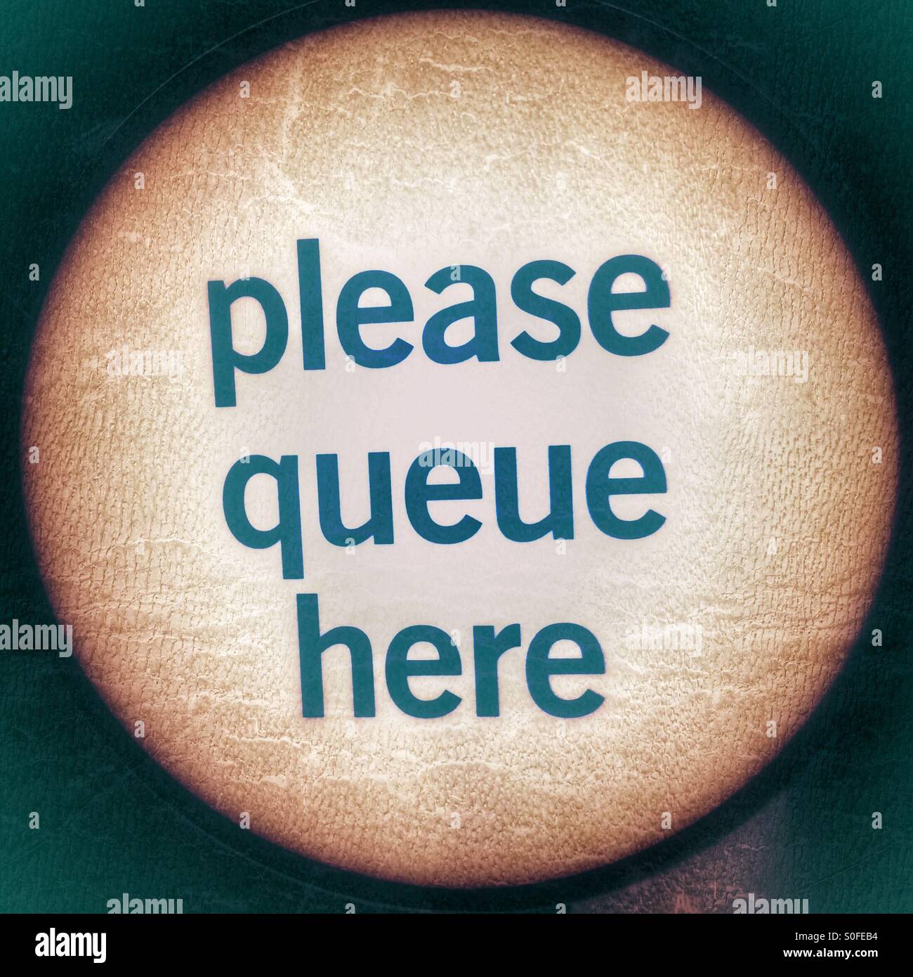 Please queue here Stock Photo - Alamy