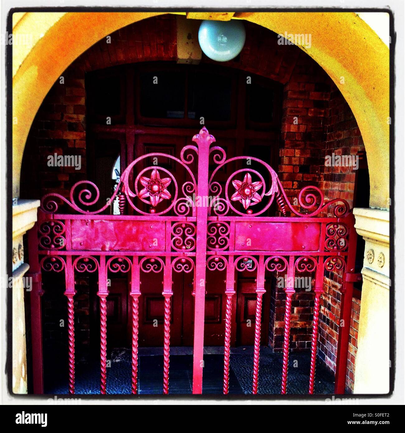 Ornate red gate Stock Photo - Alamy