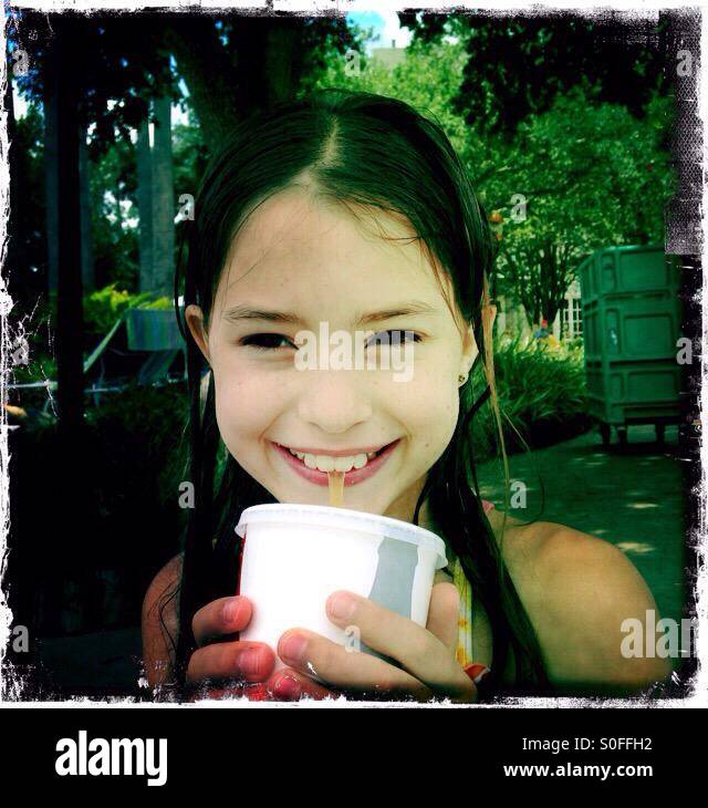 Happy girl drinking beverage Stock Photo - Alamy