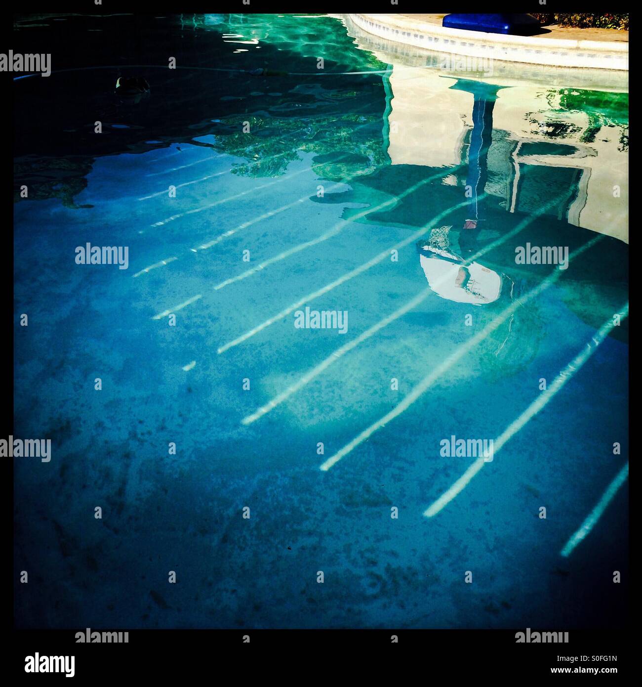 A kids basketball backboard reflected in a swimming pool Stock Photo ...