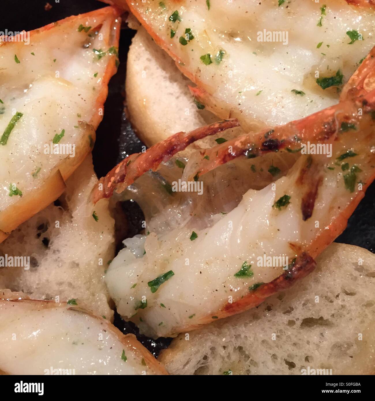 Butterfly king prawns with garlic and bread Stock Photo - Alamy