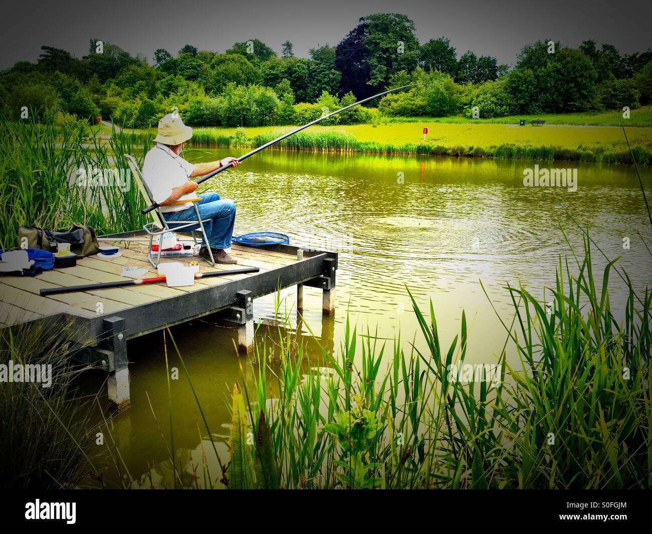 Man fishing in the English countryside Stock Photo - Alamy