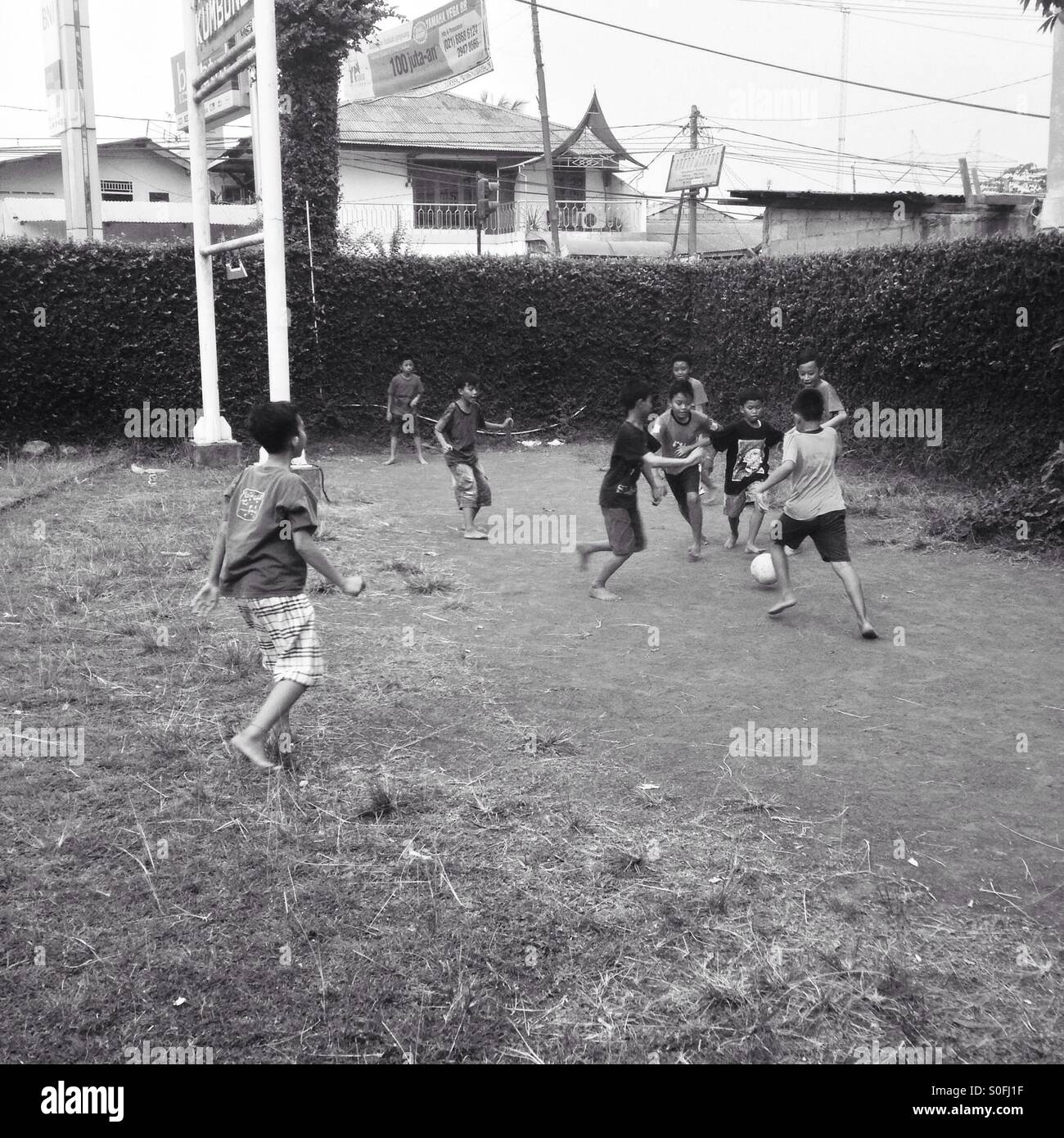 Children play football street hi-res stock photography and images - Alamy