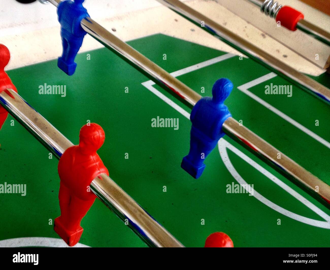 Red and blue table football men Stock Photo - Alamy