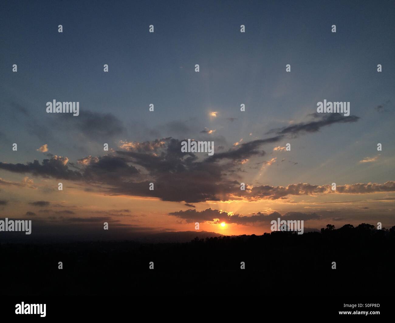 Sunset with sun beams Stock Photo - Alamy