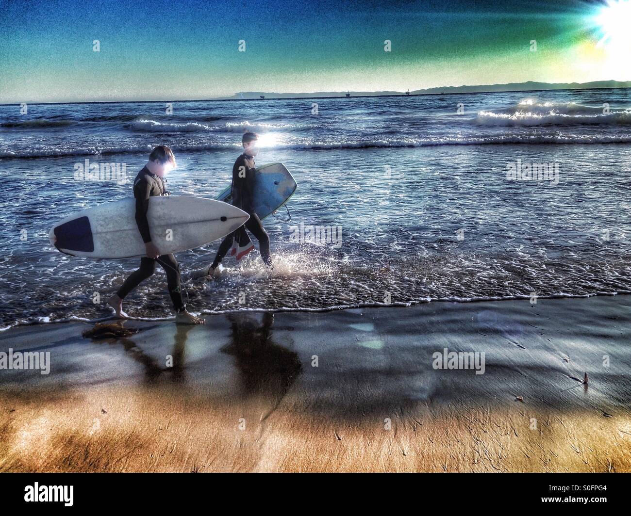 Surfers carrying surf boards hi-res stock photography and images - Alamy