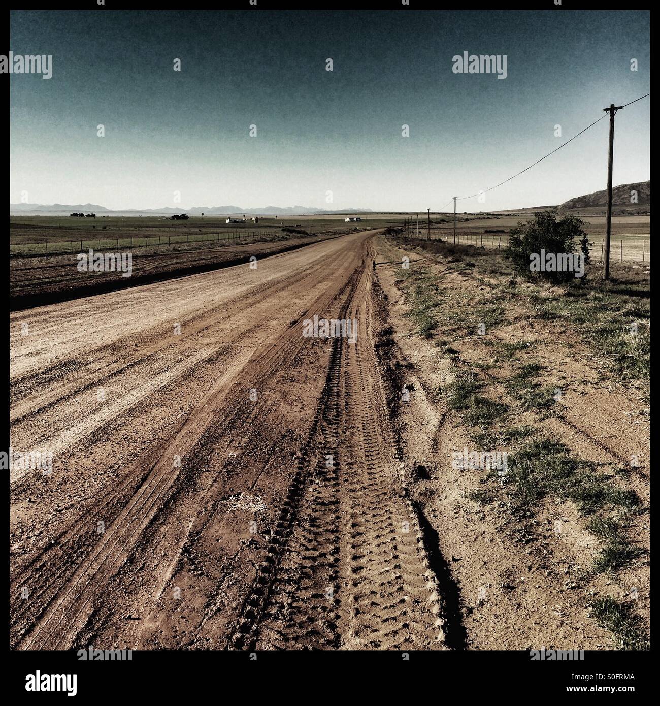 Tyre tracks on country road Stock Photo - Alamy