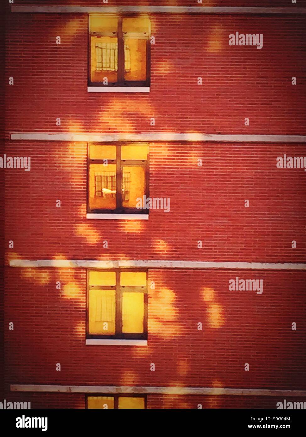 Reflected light on apartment house Windows Stock Photo - Alamy