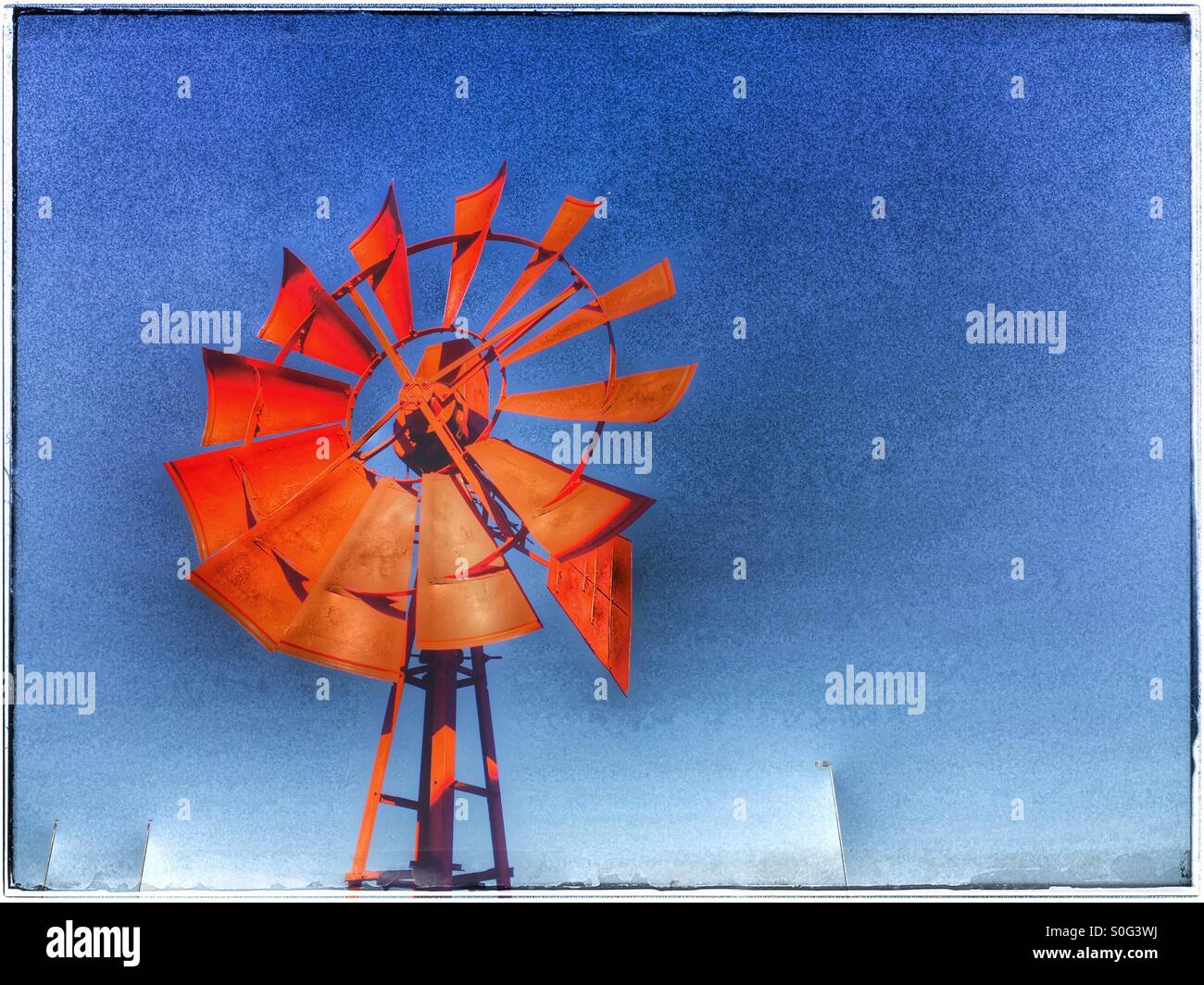Old windmill painted red Stock Photo - Alamy