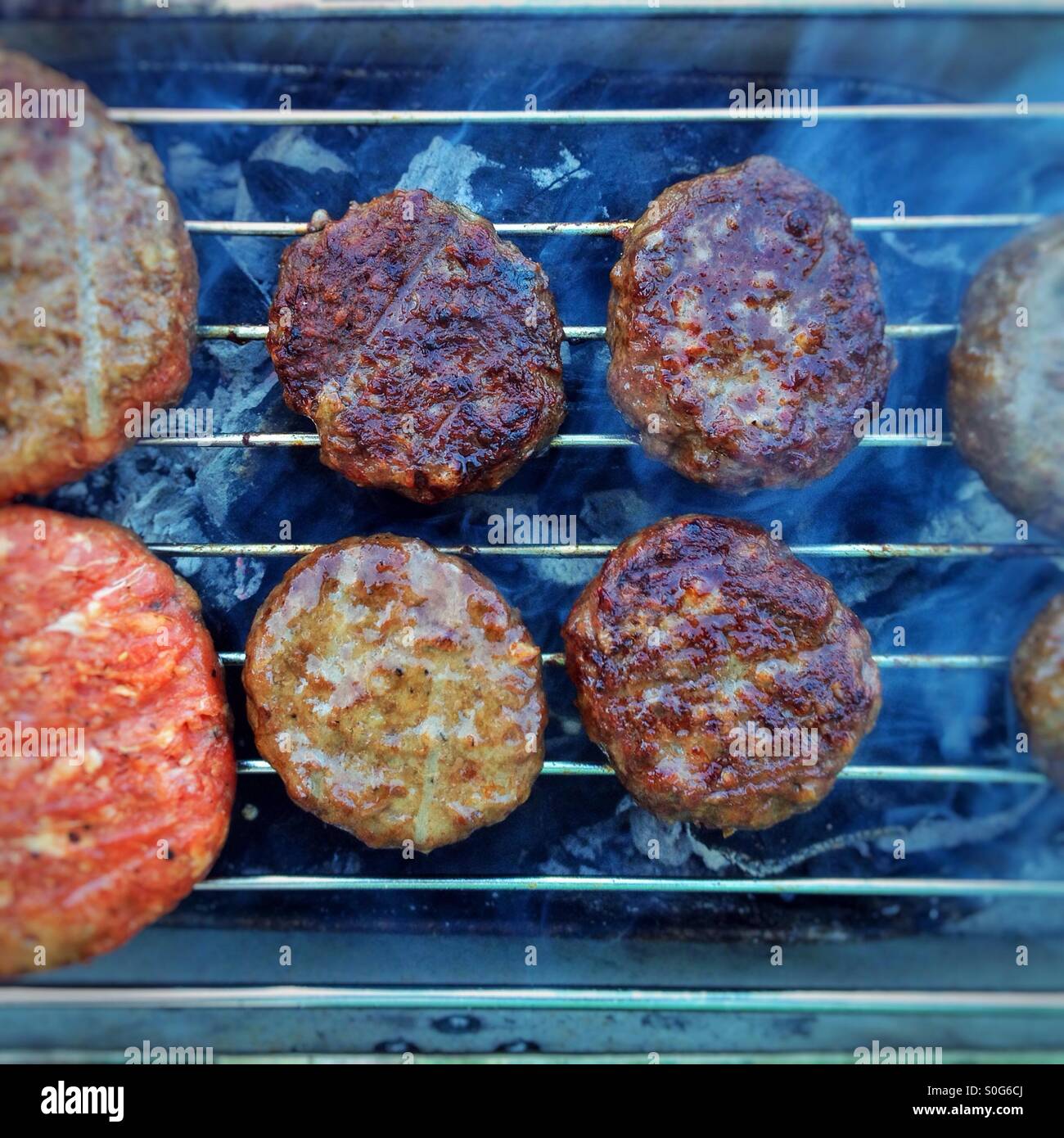 Burgers on a barbecue Stock Photo - Alamy