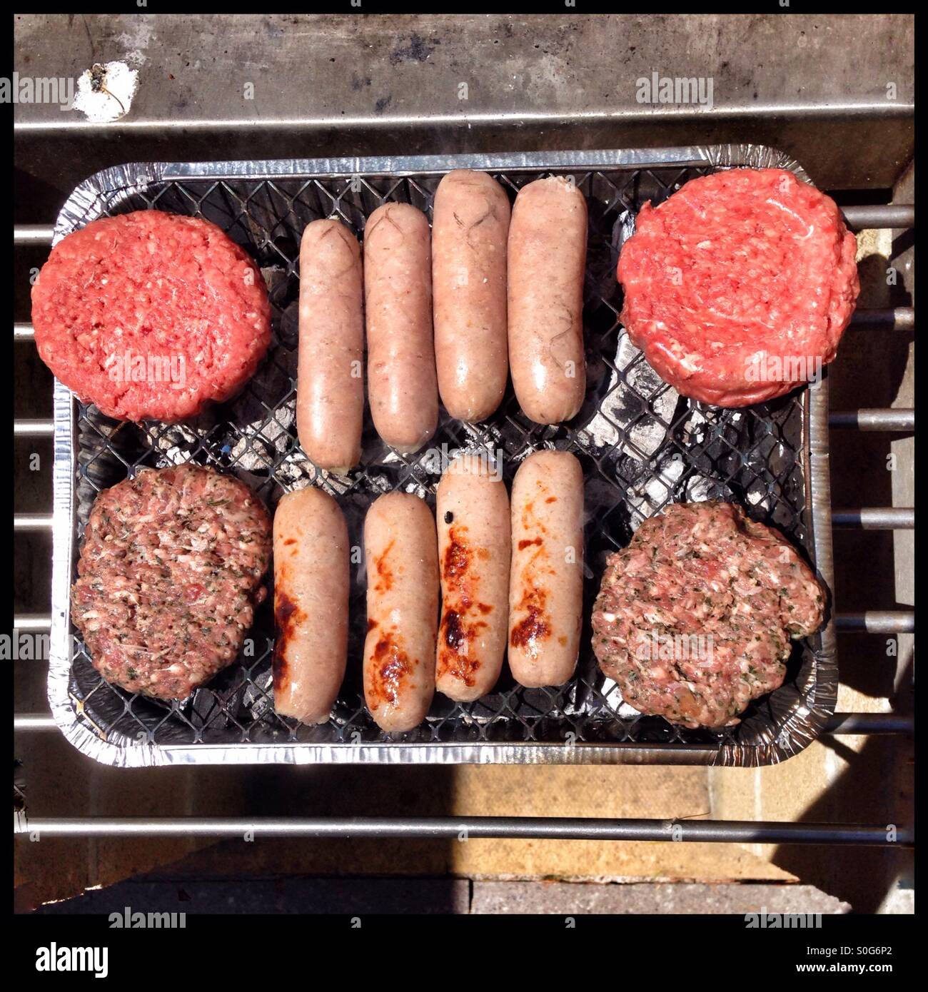 Disposable barbecue with sausages and burgers, Centre parks, Longleat ...
