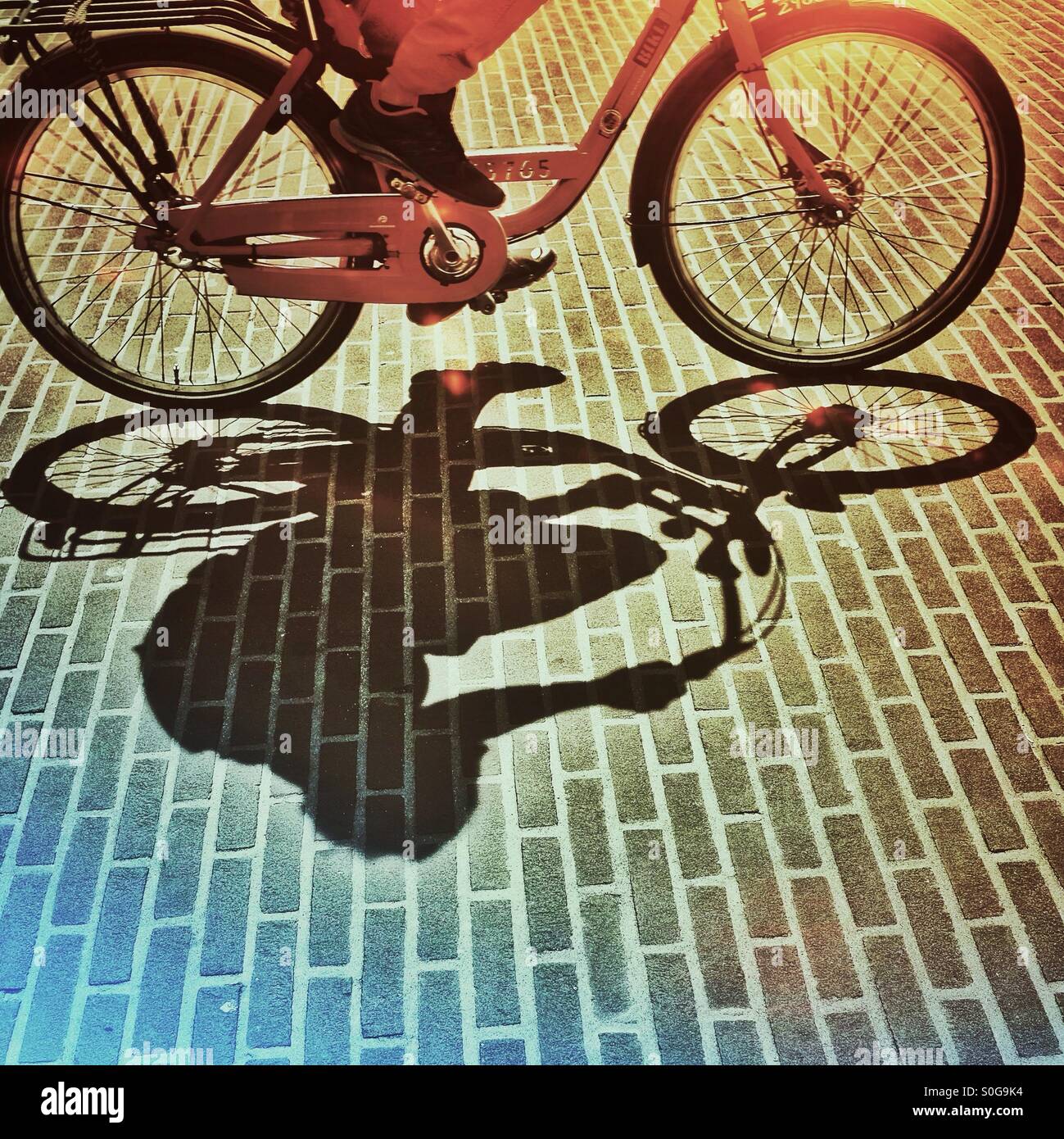 Cyclist and shadow Stock Photo - Alamy