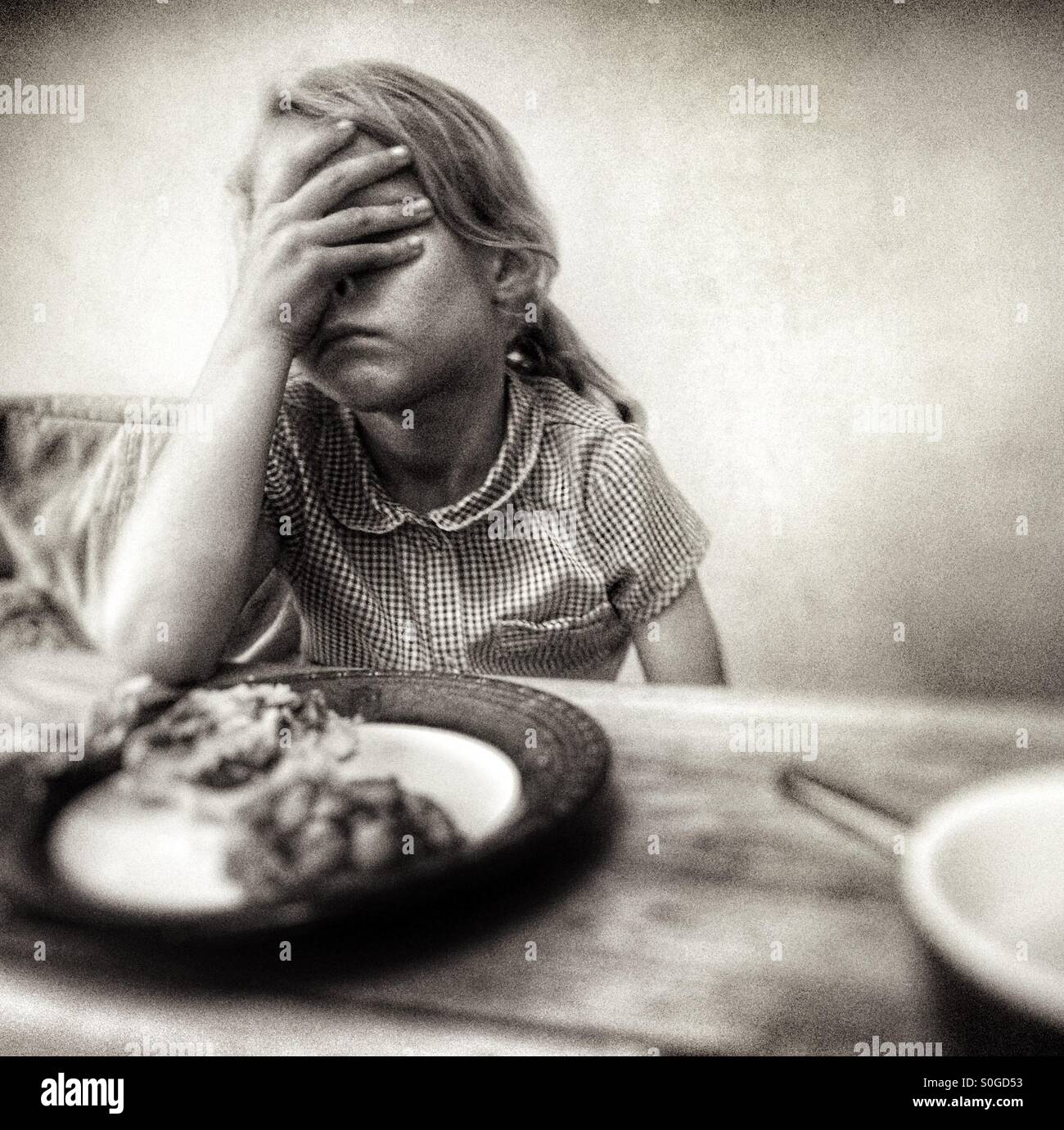 Child struggling/refusing to eat dinner. Girl, 7 years Stock Photo - Alamy