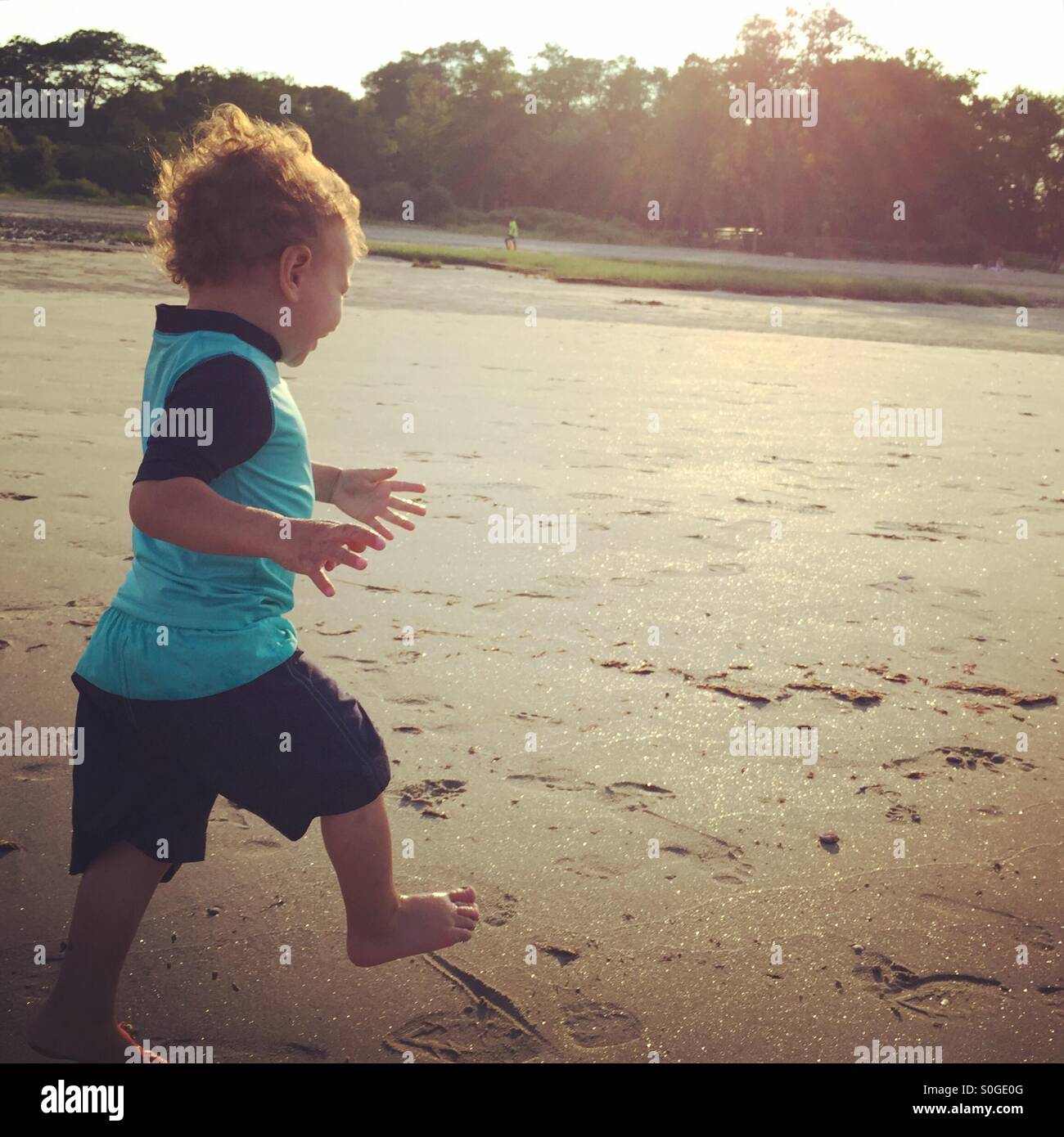 Toddler running on the beach Stock Photo - Alamy