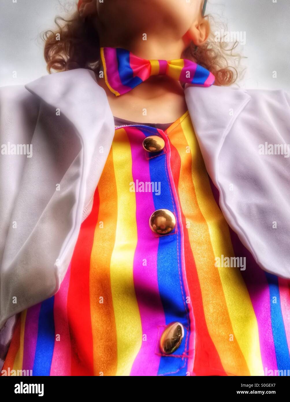 Young girl wearing colourful waistcoat Stock Photo - Alamy