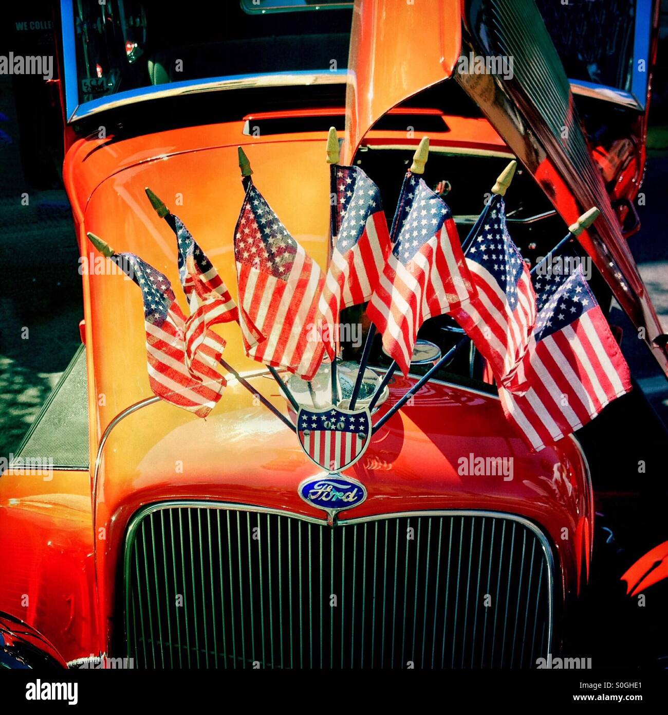Antique vintage Ford roadster automobile decorated with American flags ...