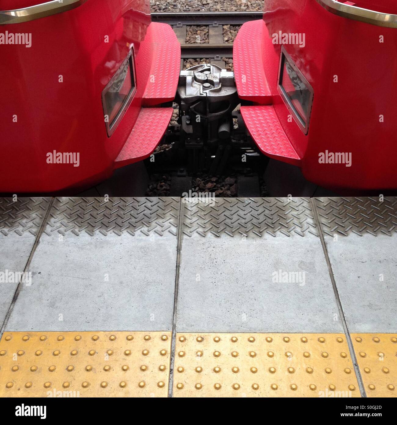 Red train cars at a station Stock Photo - Alamy