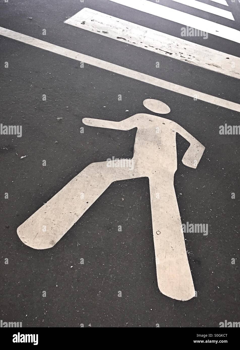Painted symbol of walking man and pedestrian crossing Stock Photo - Alamy