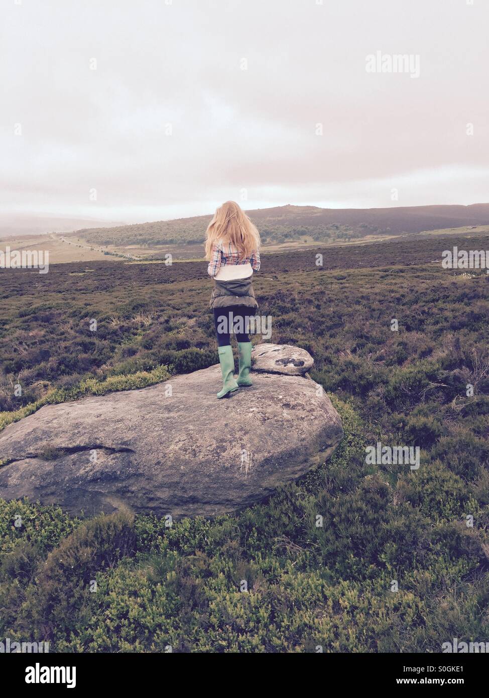 Girl standing on rock hi-res stock photography and images - Alamy