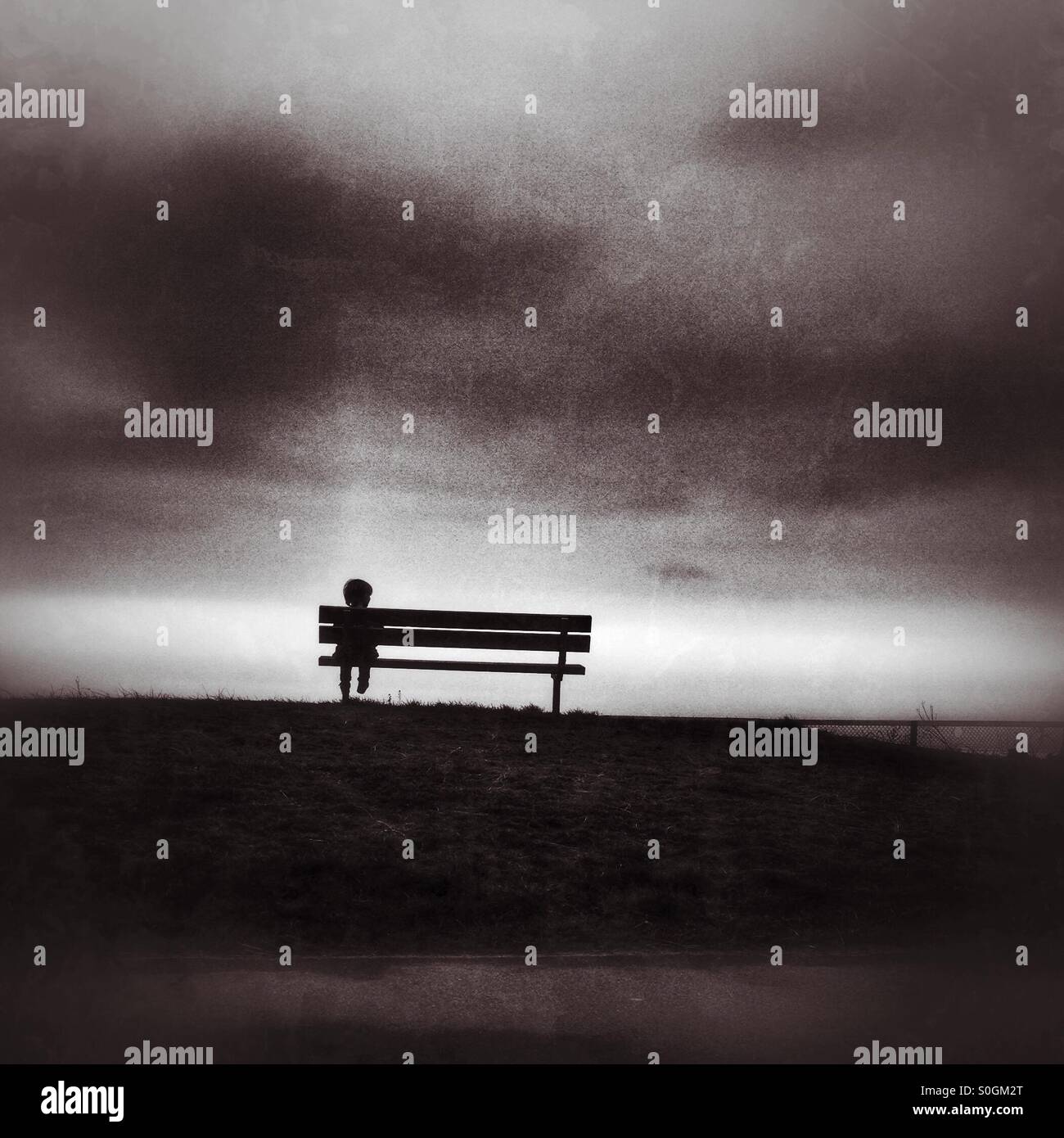Child alone on a bench Stock Photo - Alamy