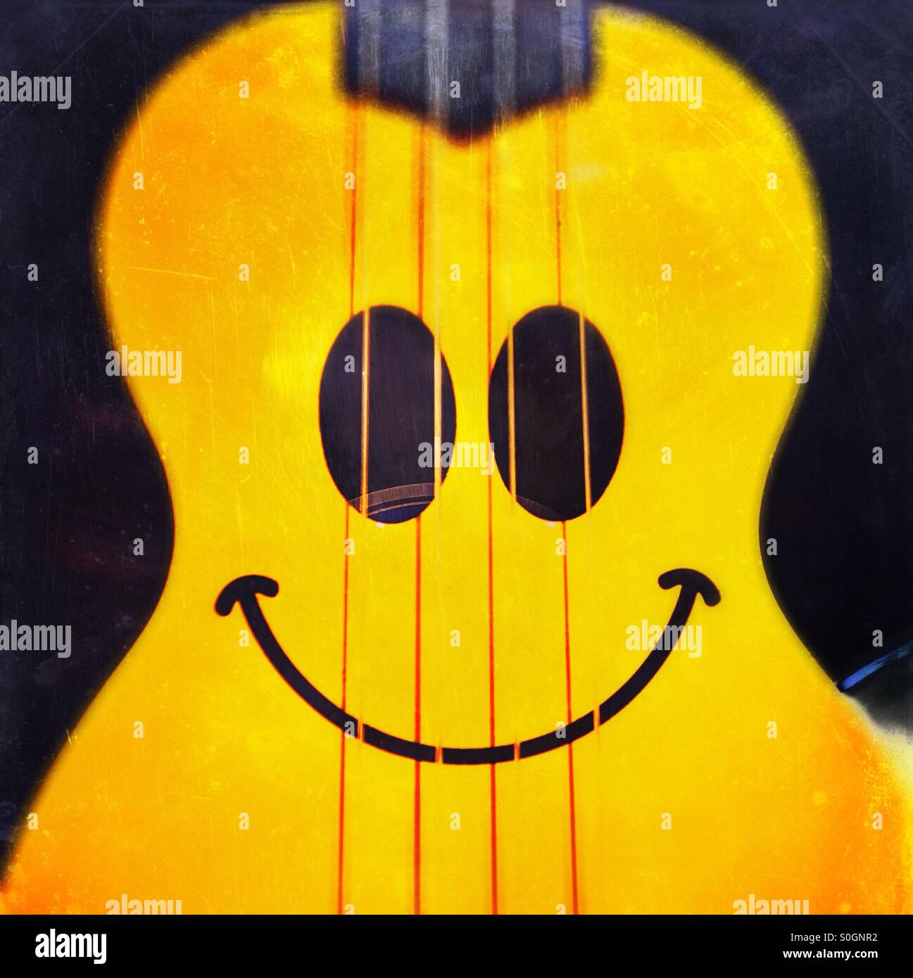 My ukulele with a smiley face waiting to be played Stock Photo - Alamy