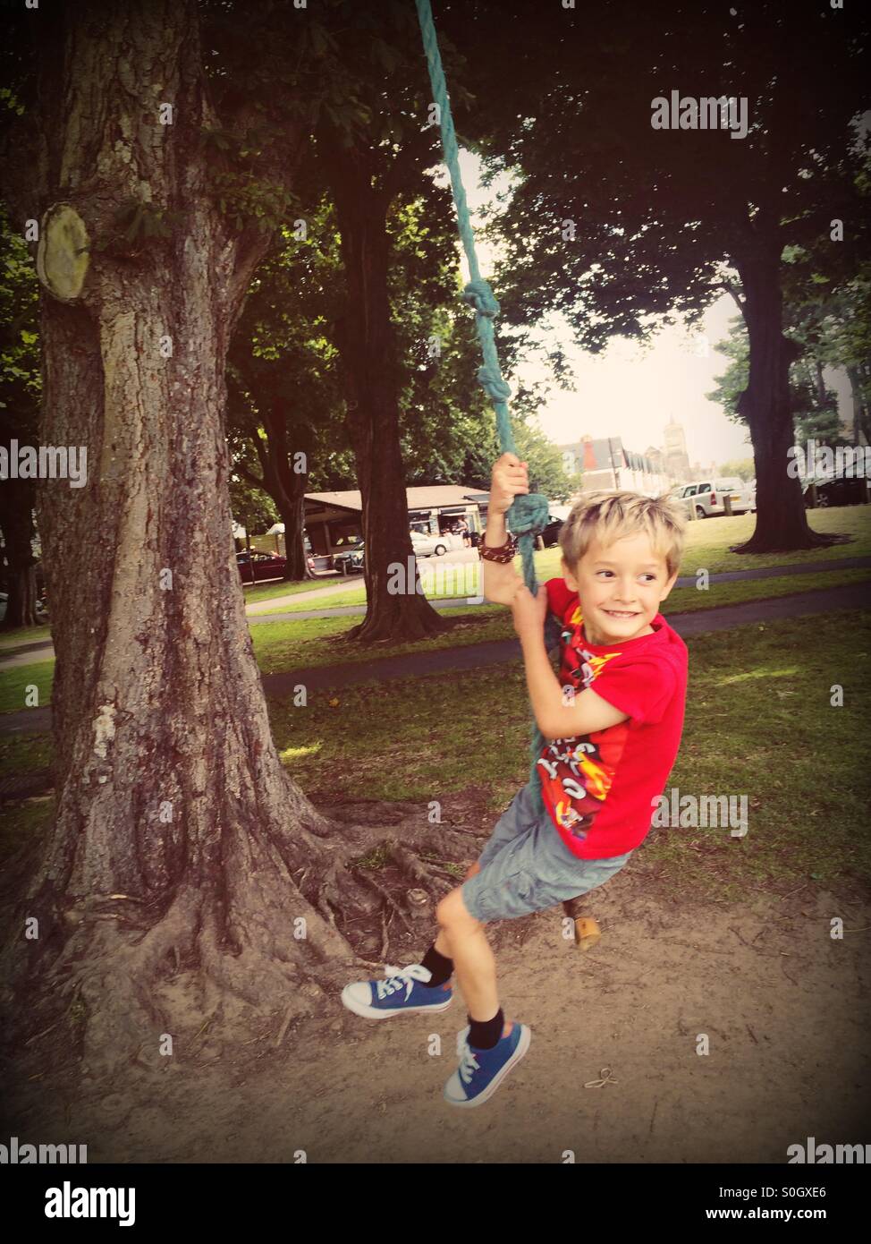Child swing tree playing hi-res stock photography and images - Alamy