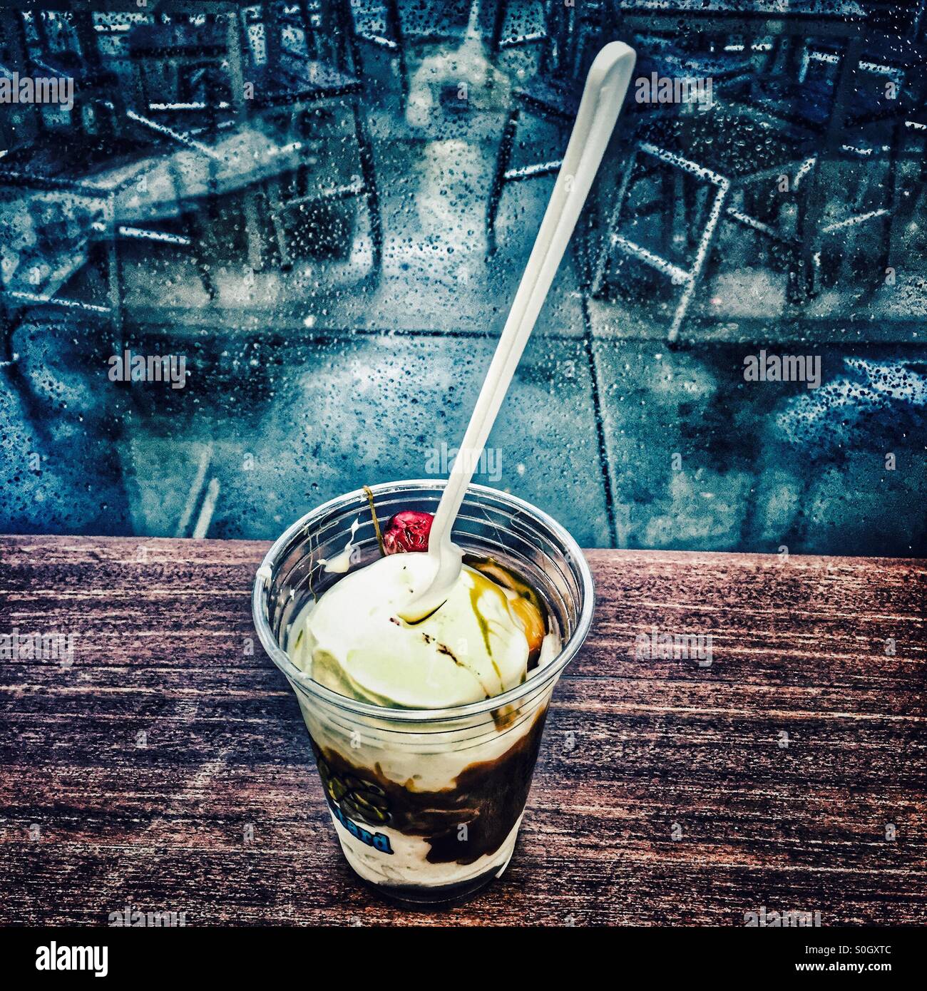 Frozen custard sundae ready to eat as a summer thunderstorm streaks the ...