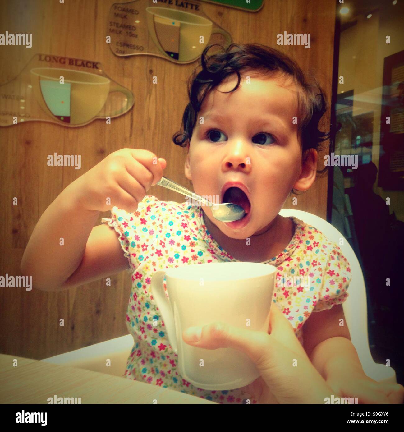 Baby girl enjoying milk Stock Photo - Alamy