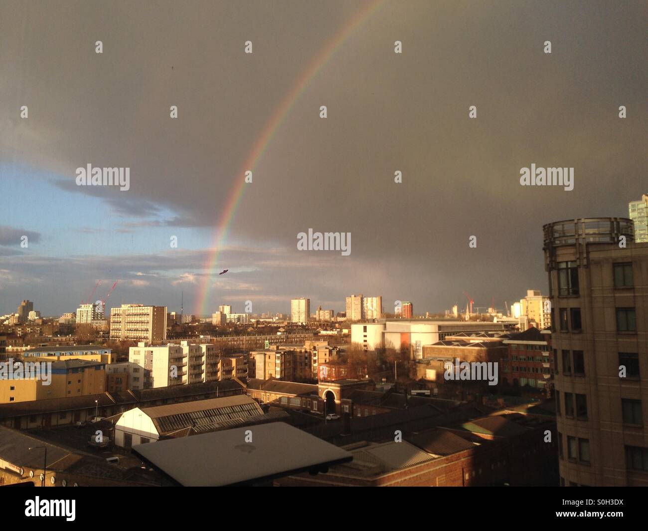 Rainbow over the City Stock Photo - Alamy