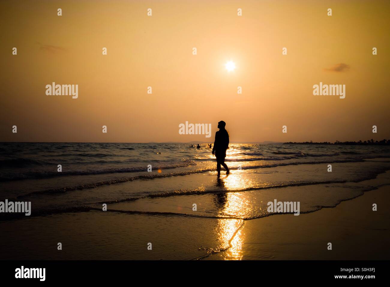 The woman walking in the sunset Stock Photo - Alamy