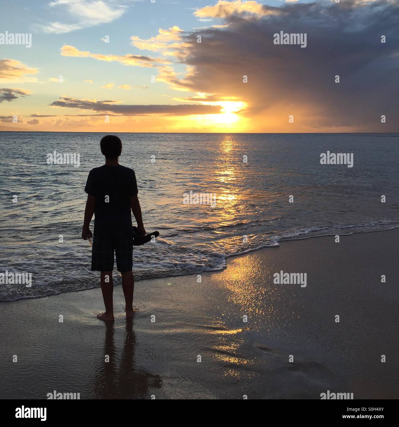 Child watching the waves at sunset hi-res stock photography and images ...