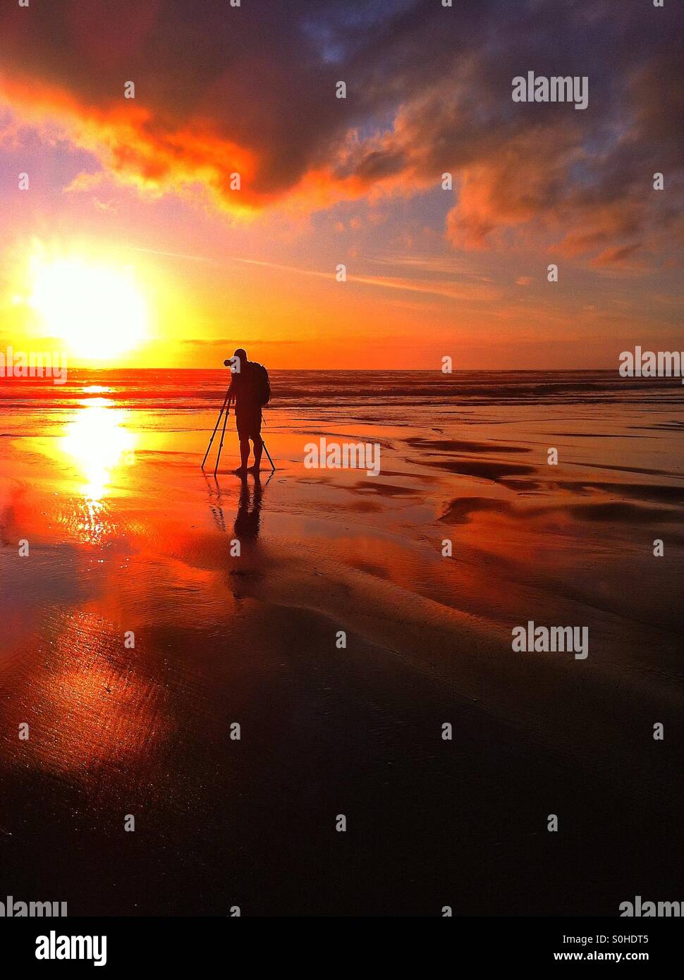 Photographer capturing the sunset Stock Photo - Alamy