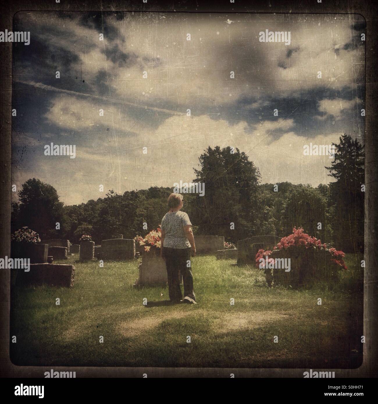 A lady walking through a cemetery (1 Stock Photo - Alamy