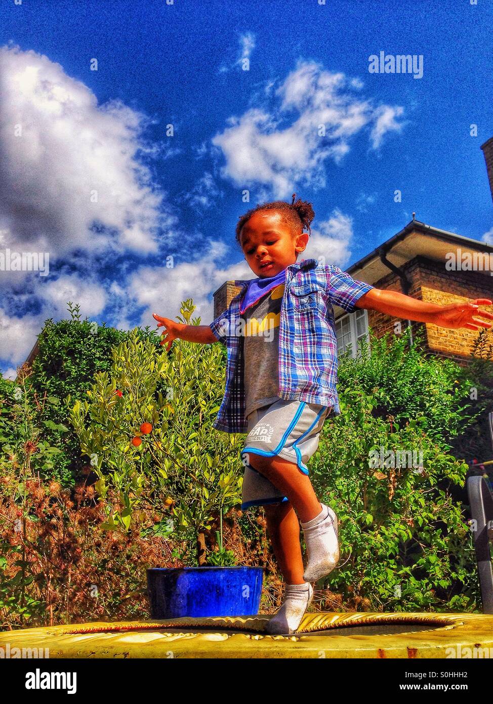 Child jumping on a trampoline Stock Photo - Alamy