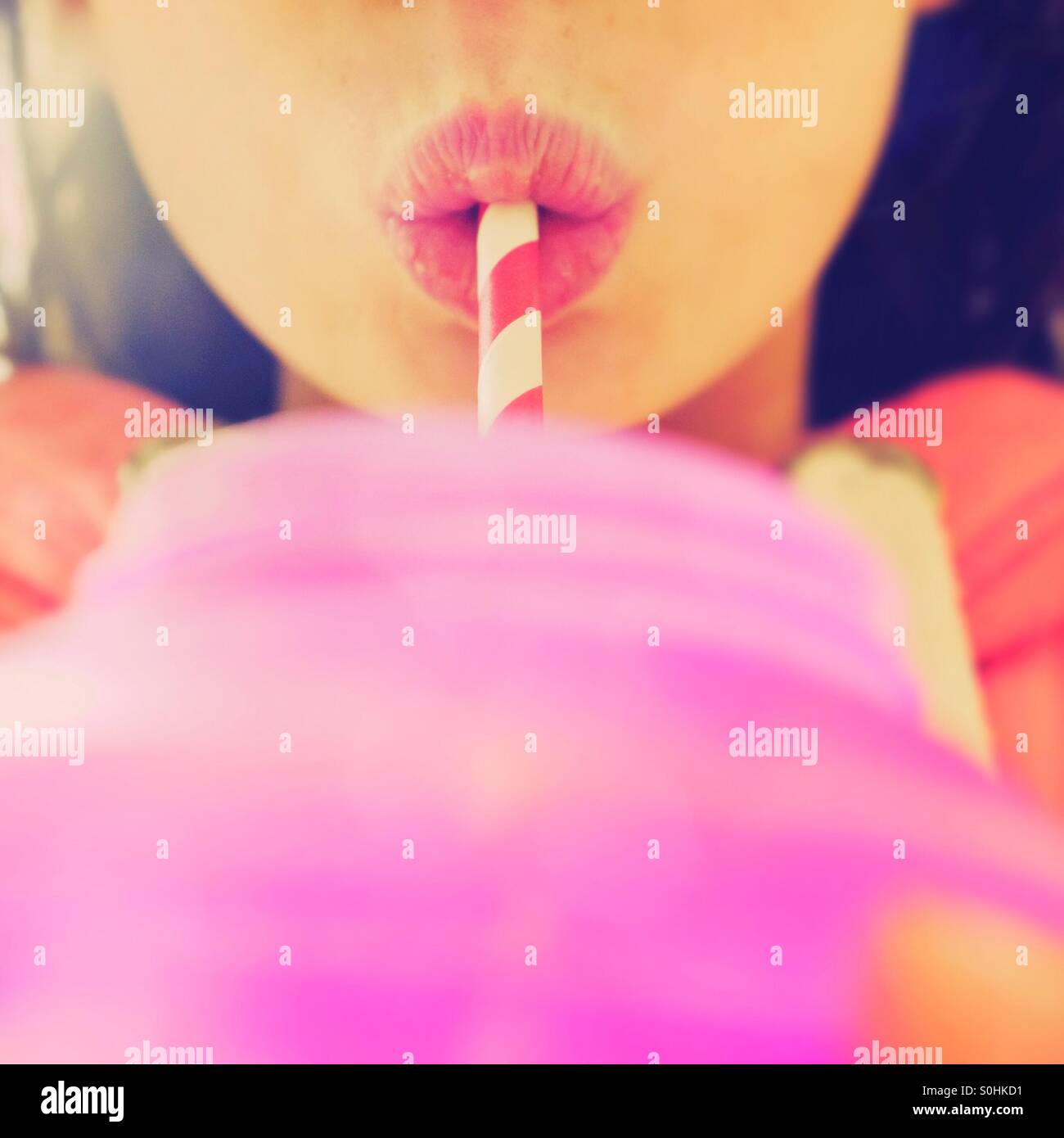 Young girl drinking with a straw Stock Photo - Alamy