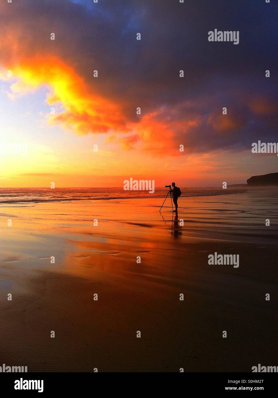 Photographer capturing the sunset Stock Photo - Alamy