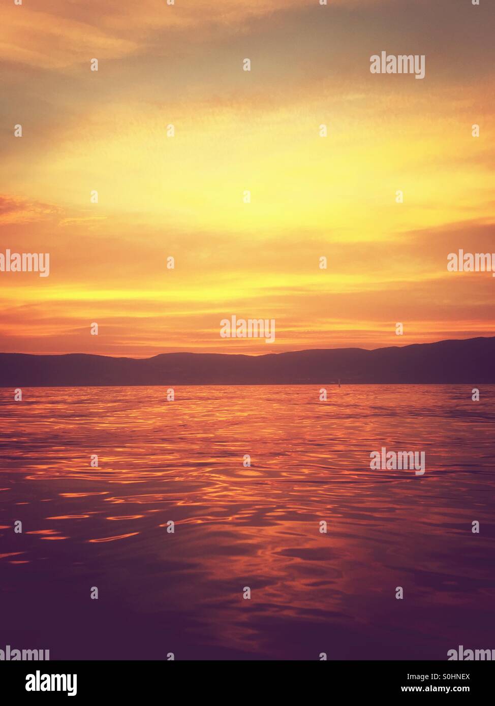 Bright summer sunset over lake Stock Photo - Alamy