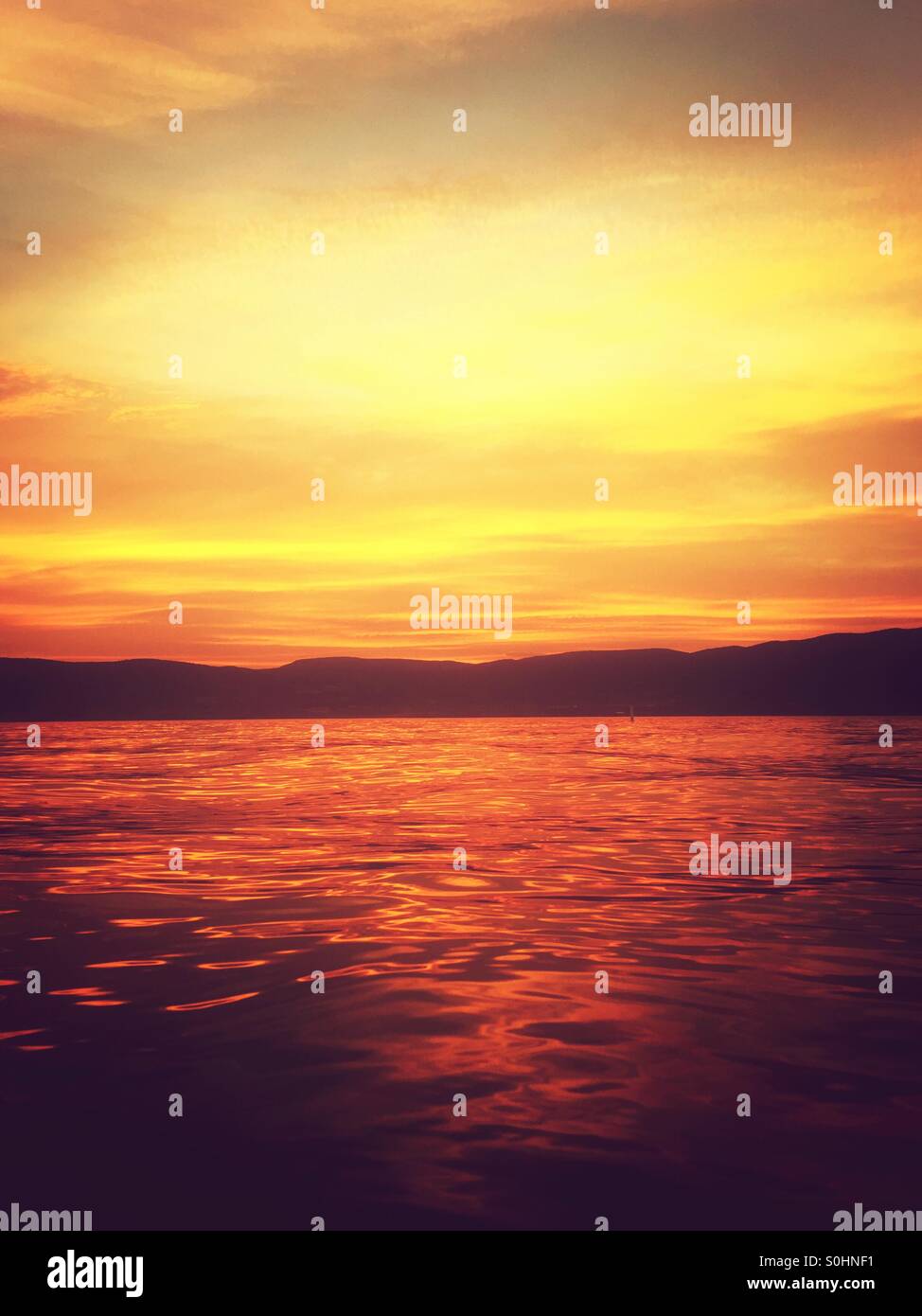 Fiery summer sunset over lake Stock Photo - Alamy