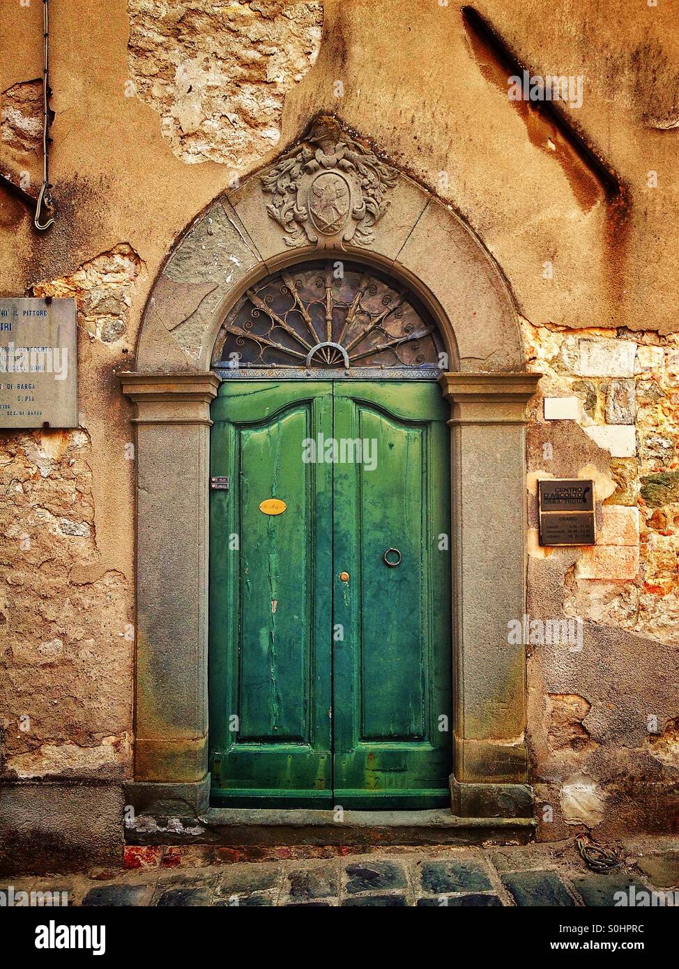 Old green arched doorway in Barga Italy Stock Photo - Alamy
